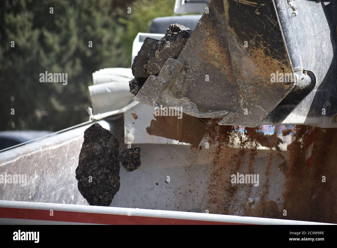 Digger Bucket Emptying Load into Dump Truck Stock Photo - Alamy