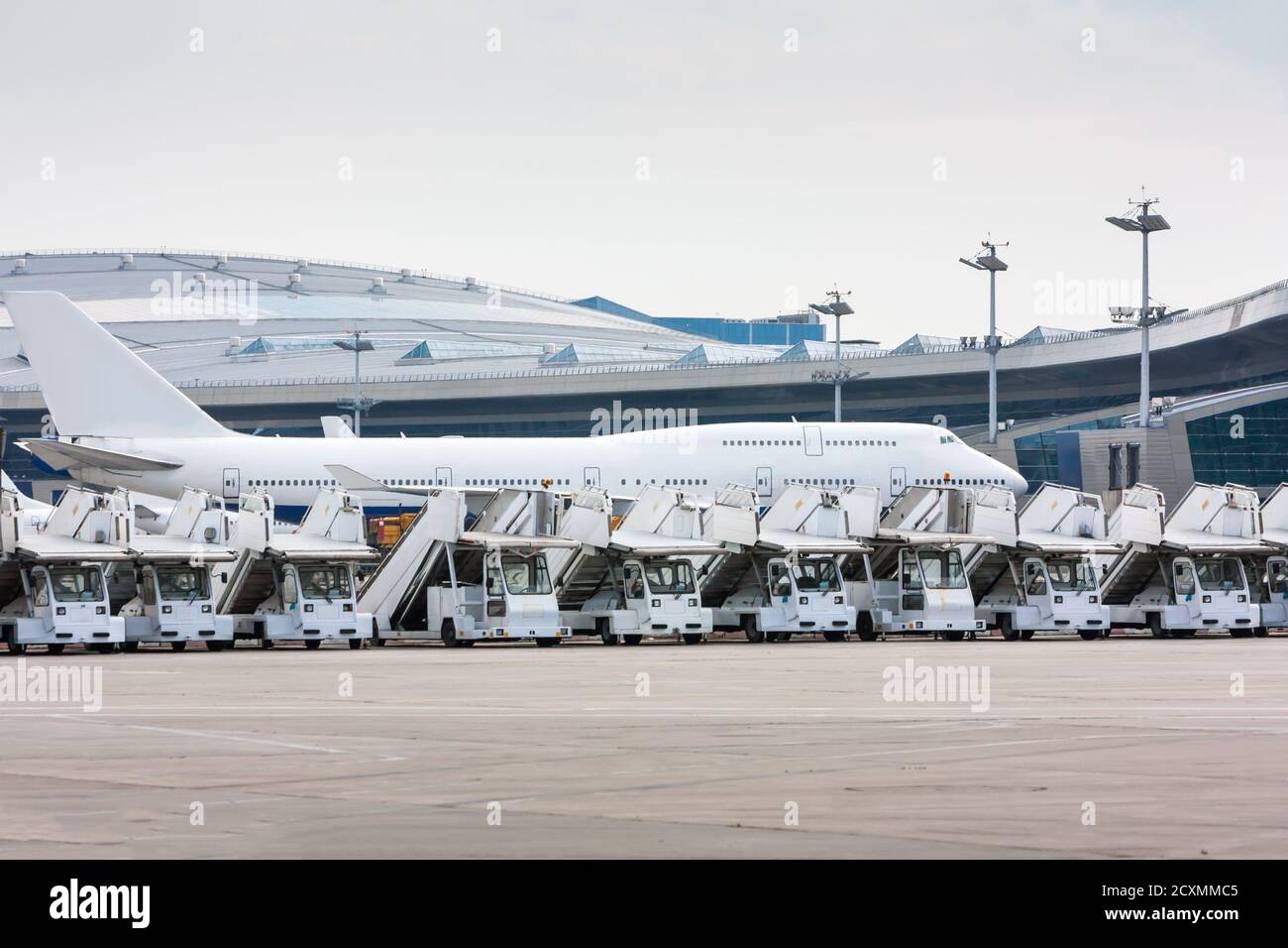 Passenger airplane near the airport terminal behind the rows of ...