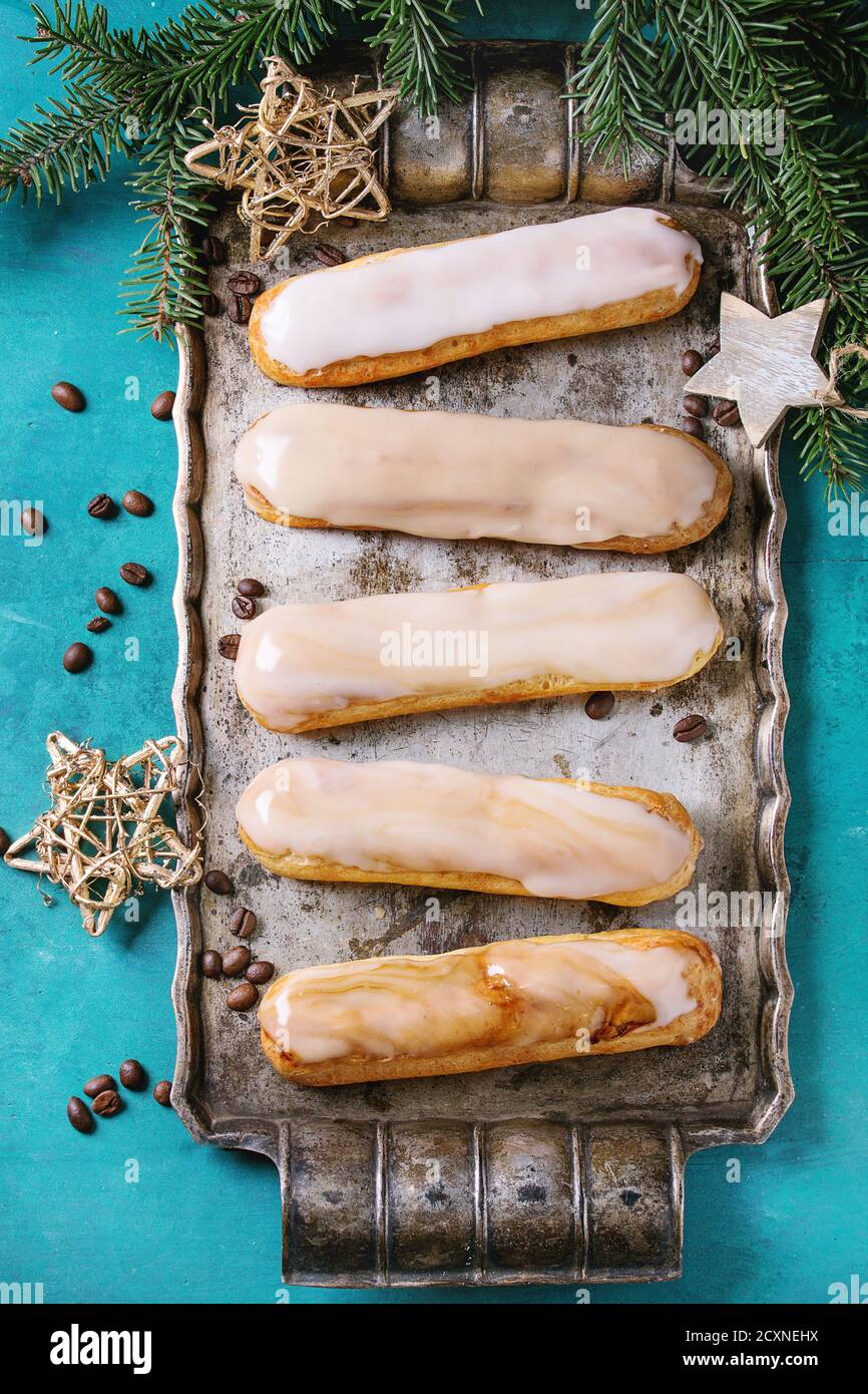 Homemade Coffee eclairs with coffee beans on vintage metal tray ...