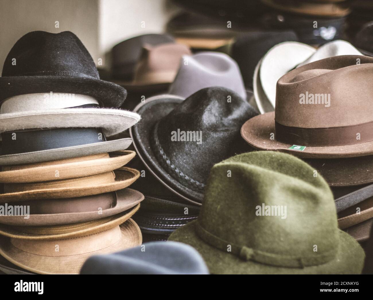Different colored hats stacked on top of each other and ready to be ...