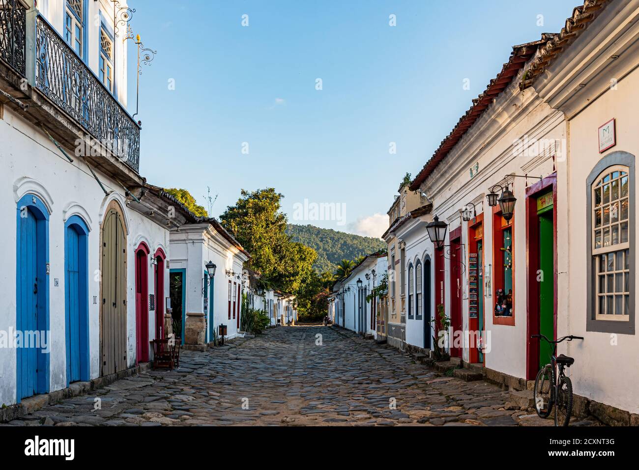 Street view of historical town in Brazil showing colonial houses with ...