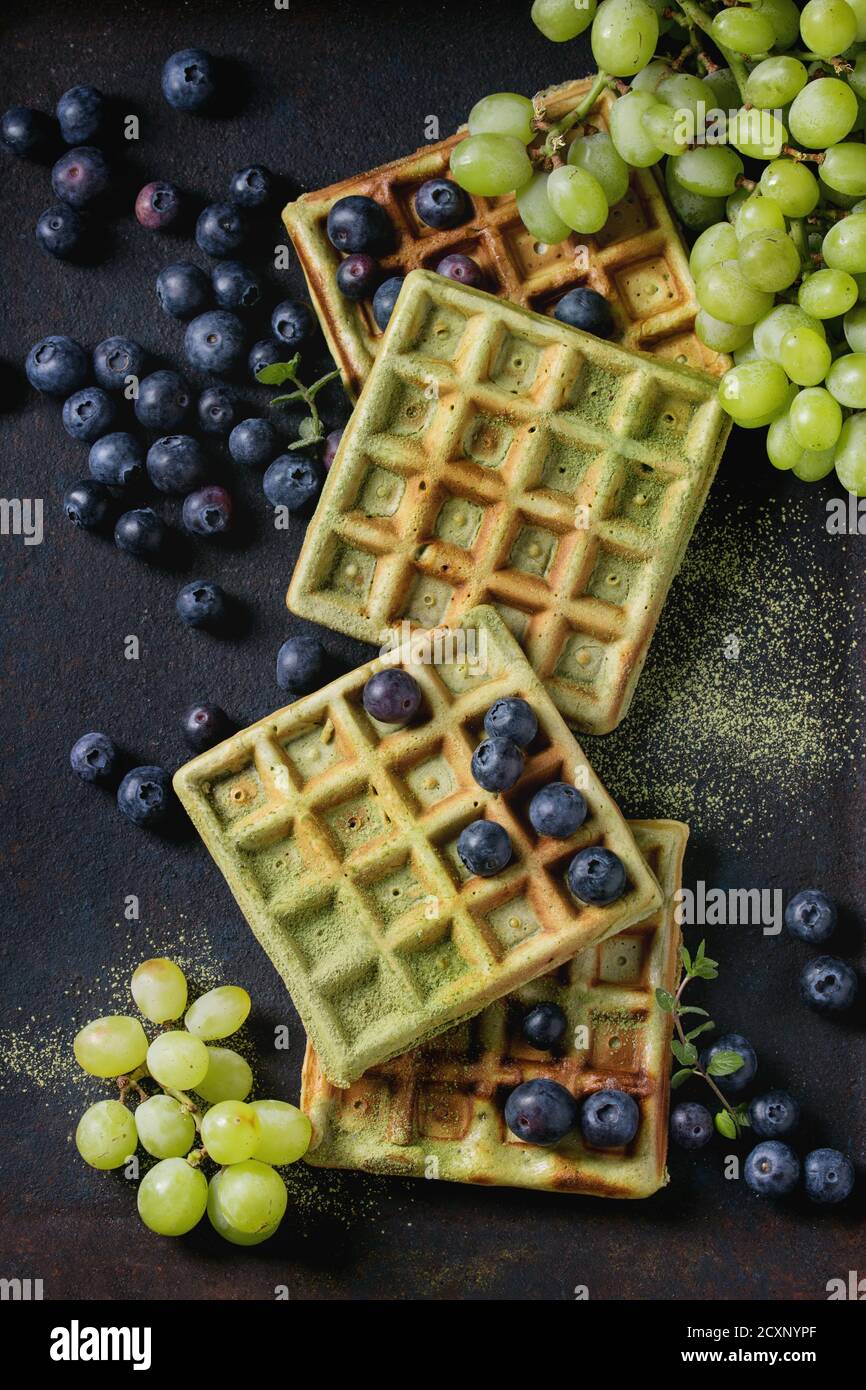 Homemade square green matcha belgian waffles with fresh ripe grapes ...