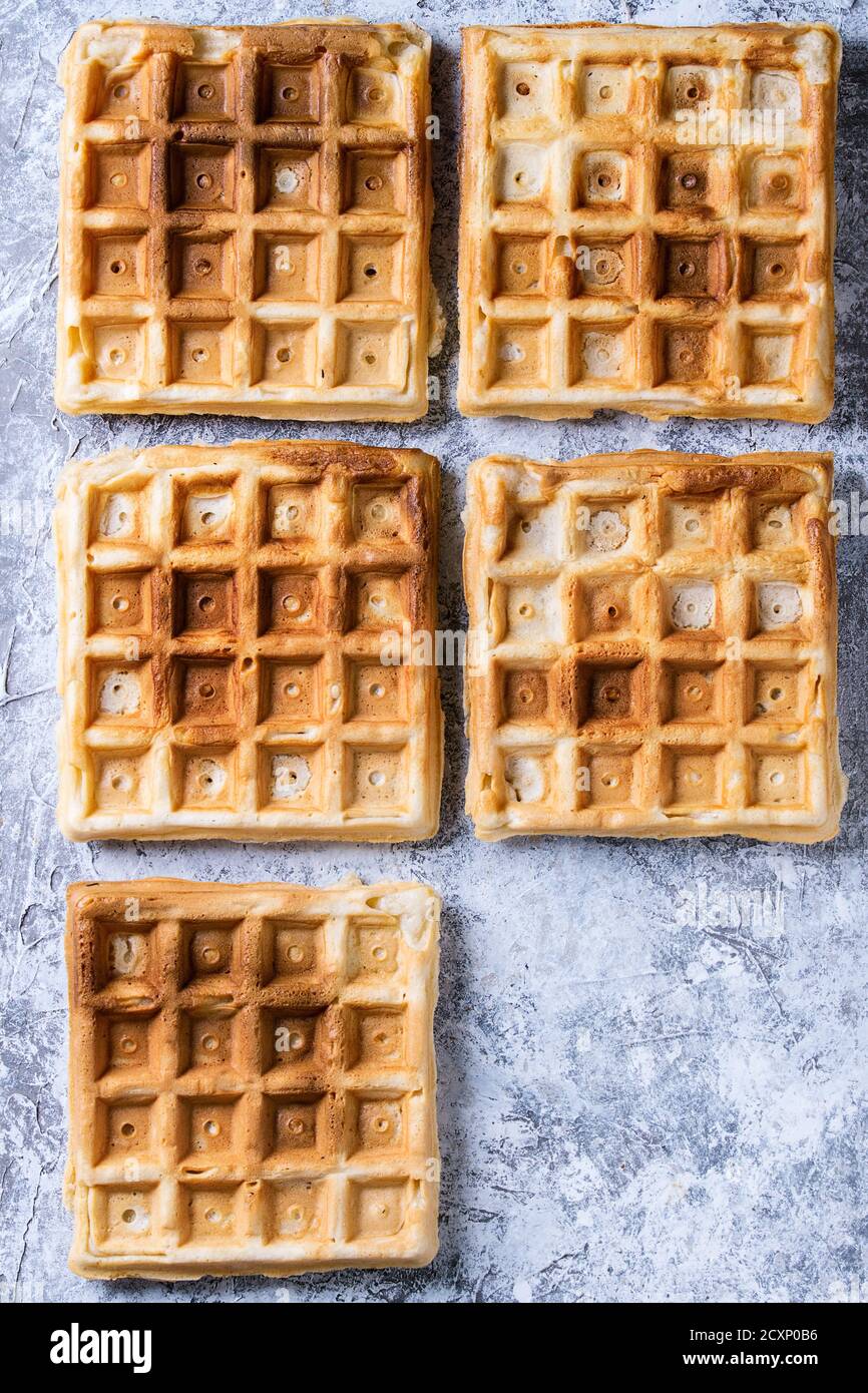 Empty homemade square belgian waffles over gray texture background. Top ...