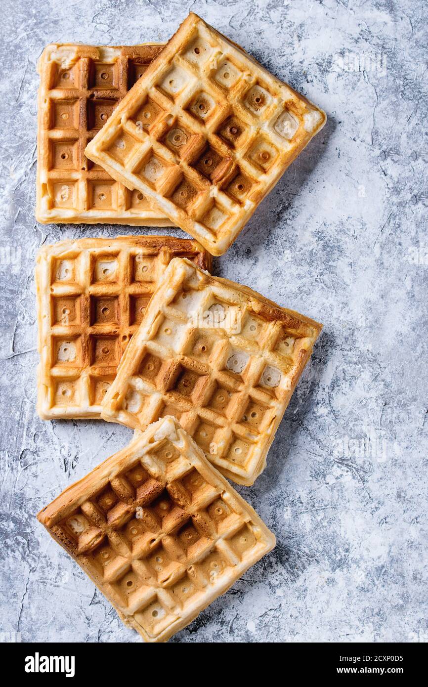 Empty homemade square belgian waffles over gray texture background. Top ...