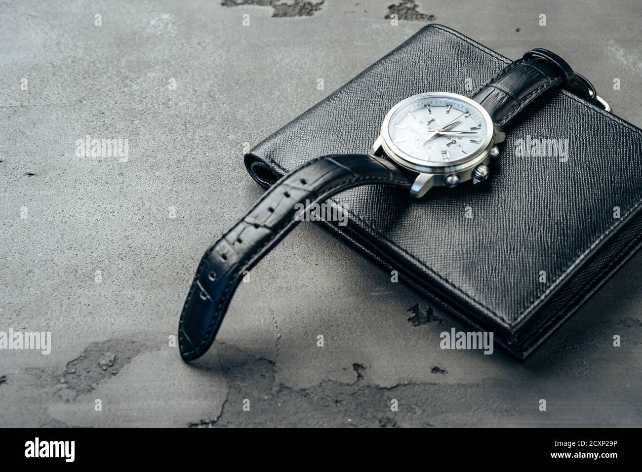 Male watch and leather wallet on dark grey surface Stock Photo - Alamy