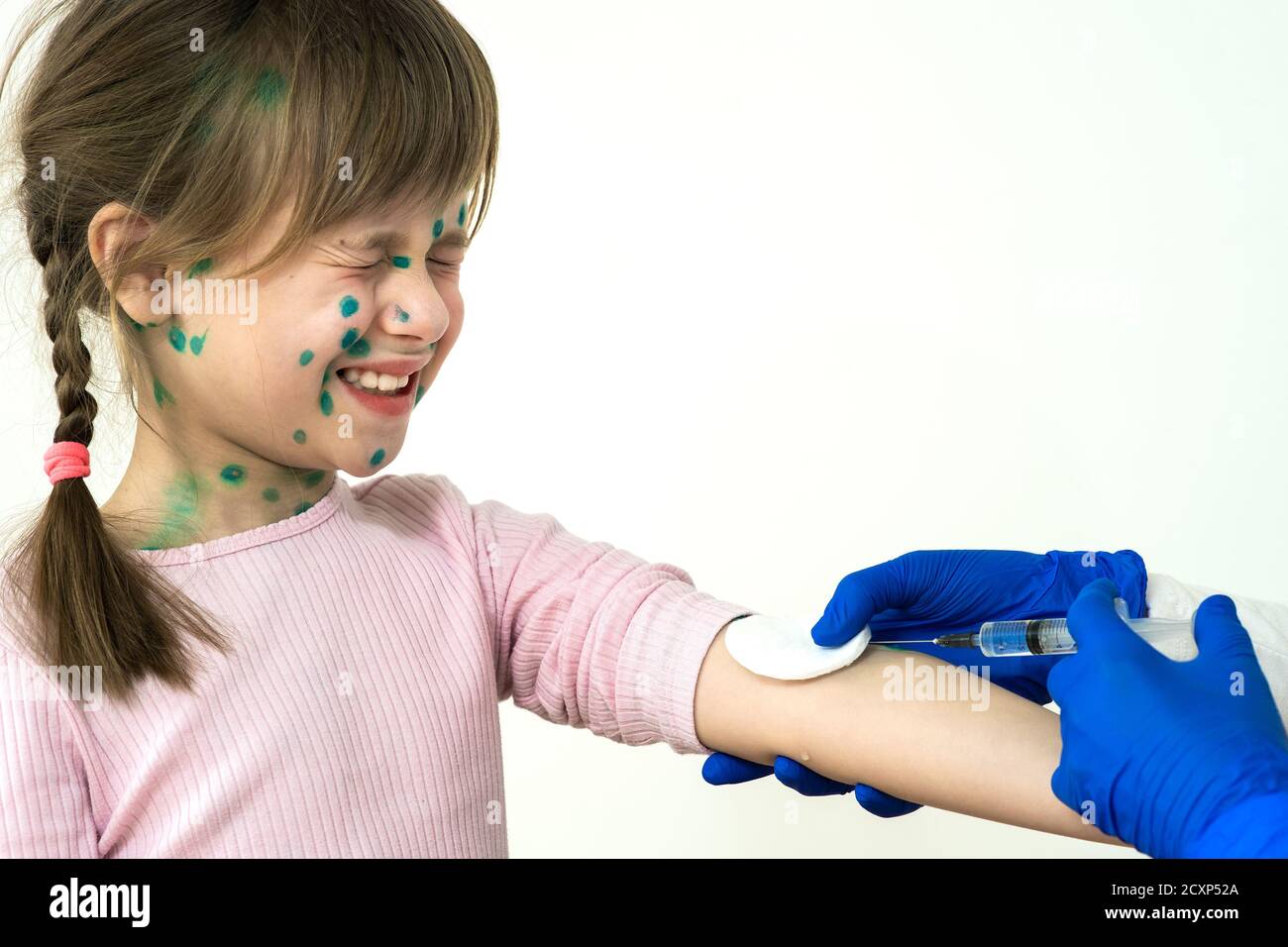 Doctor making vaccination injection to an afraid child girl sick with ...