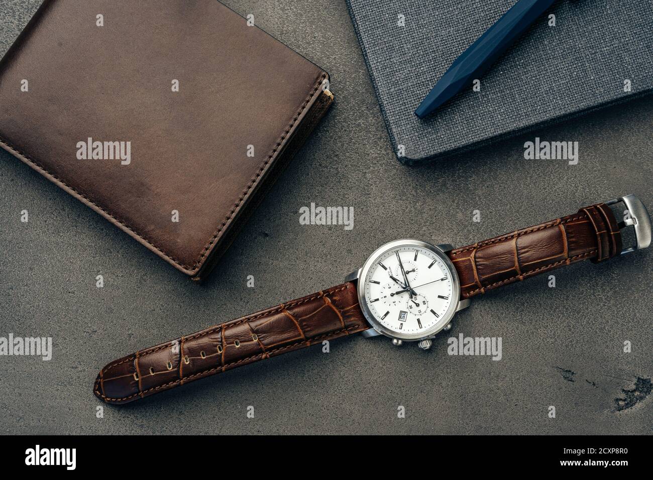 Male watch and leather wallet on dark grey surface Stock Photo - Alamy