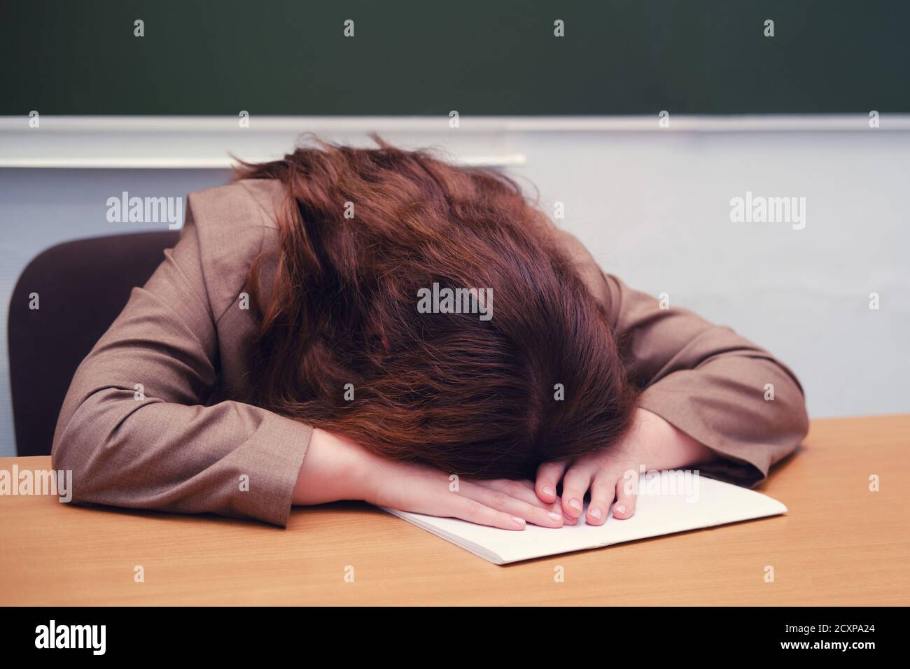Woman teacher problem, new normal sleeping on a desk at school ...