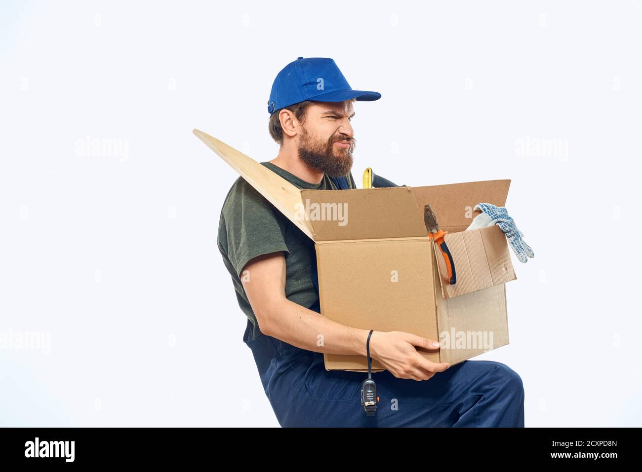 Worker man in uniform with a box in his hands tools delivery service ...