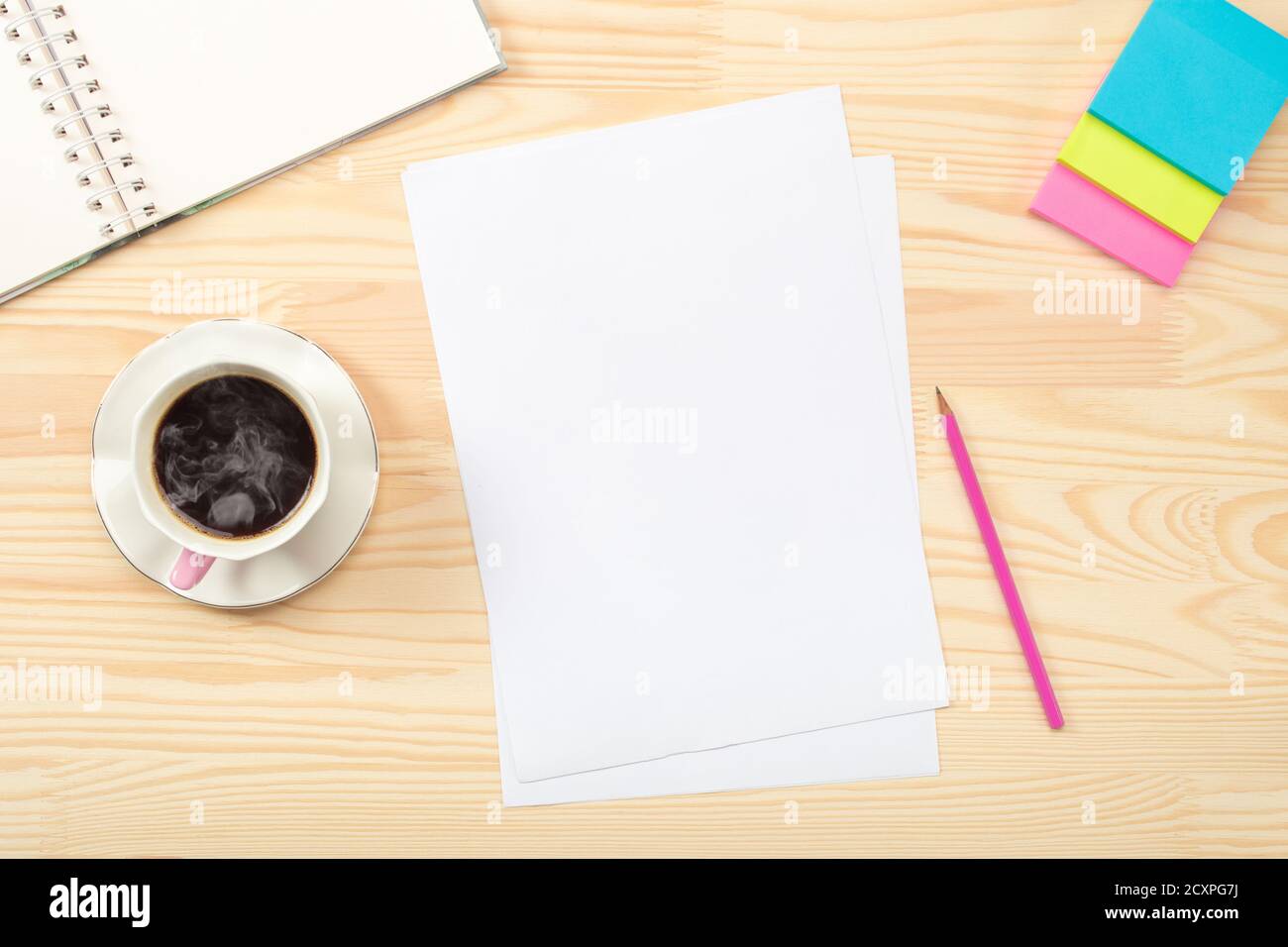 workspace on wooden table with blank sheet of paper. Desktop mix on a ...