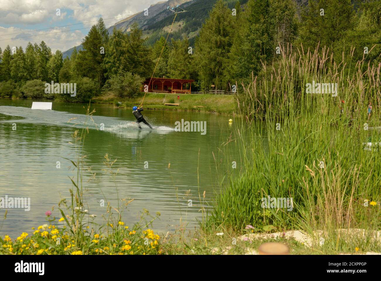 Tasch, Switzerland - 18 July 2020: man practicing wakeboard on the lake ...