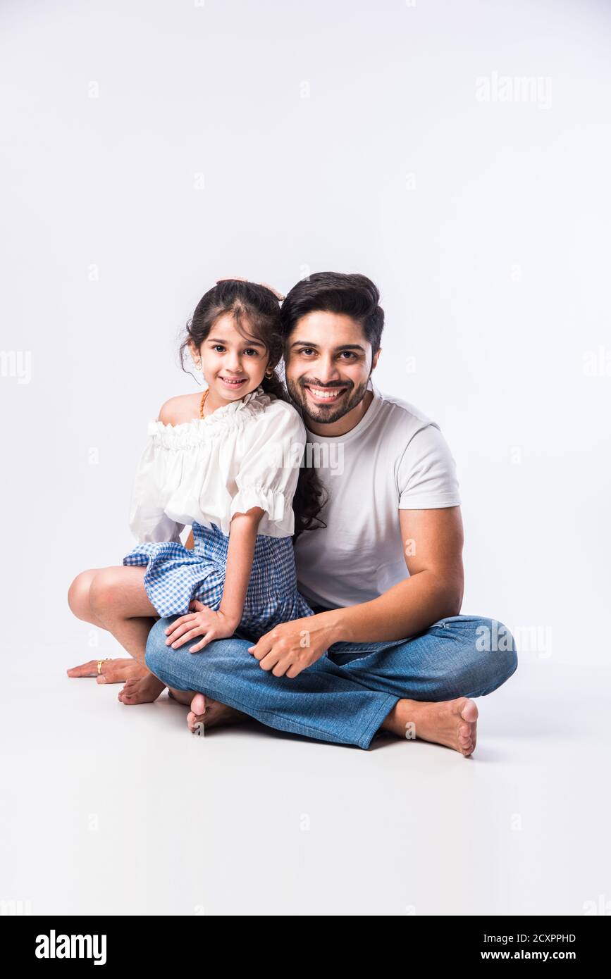 Loving Indian daddy embracing cute little adorable daughter sitting ...