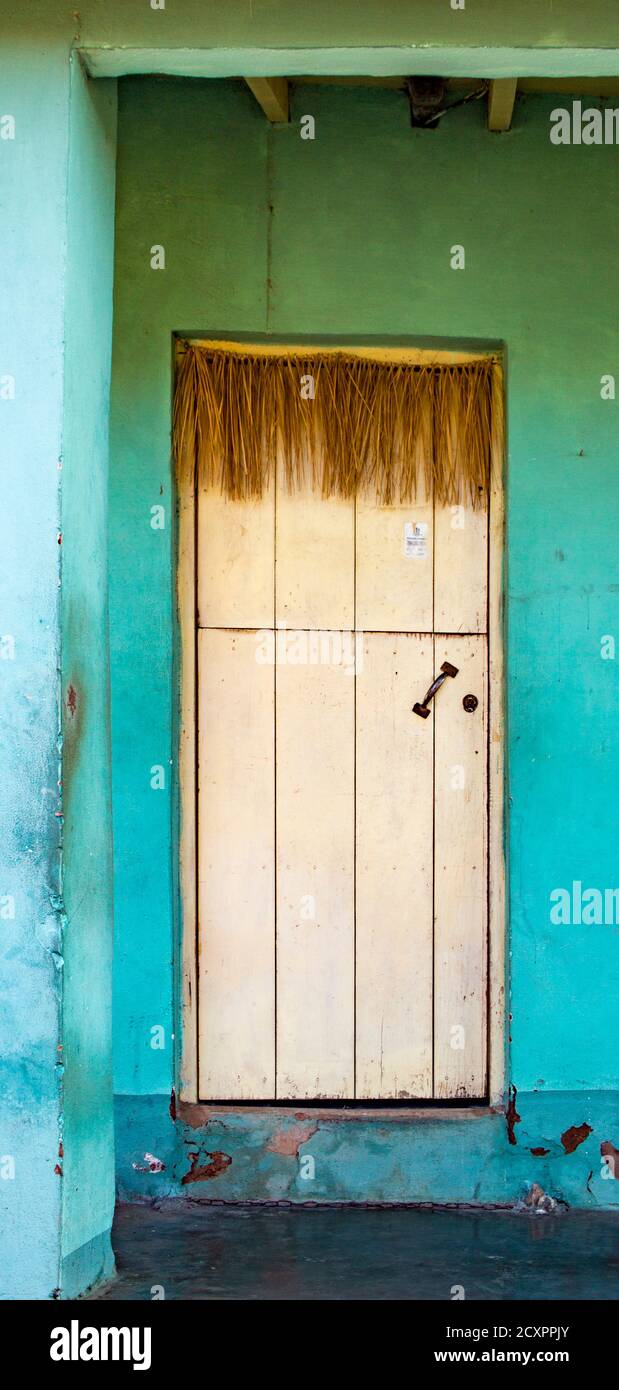 Trinidaad, Cuba Nov 26, 2017 - Yellow door with brown fringe on blue ...