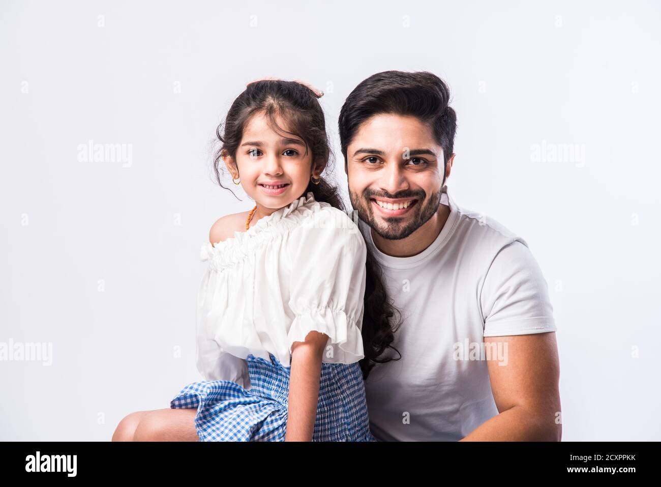Loving Indian daddy embracing cute little adorable daughter sitting ...