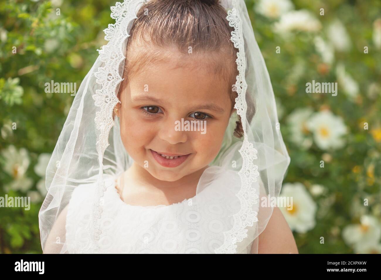A little girl in a white dress of the bride in nature Stock Photo - Alamy