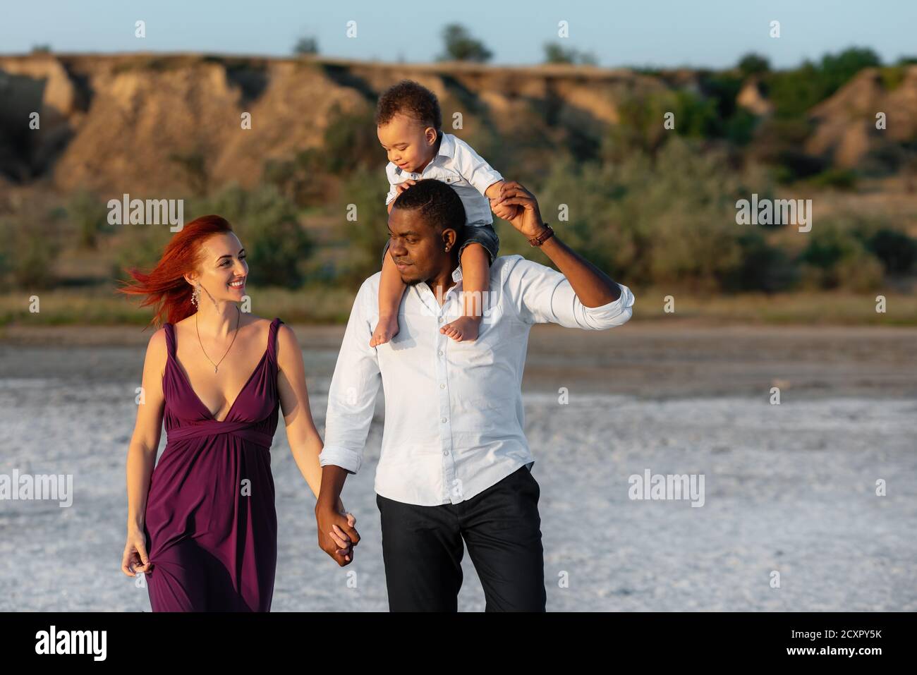 A loving mixed race family enjoying the walk. Happy harmonious family ... A loving mixed race family enjoying the walk. Happy harmonious family ...