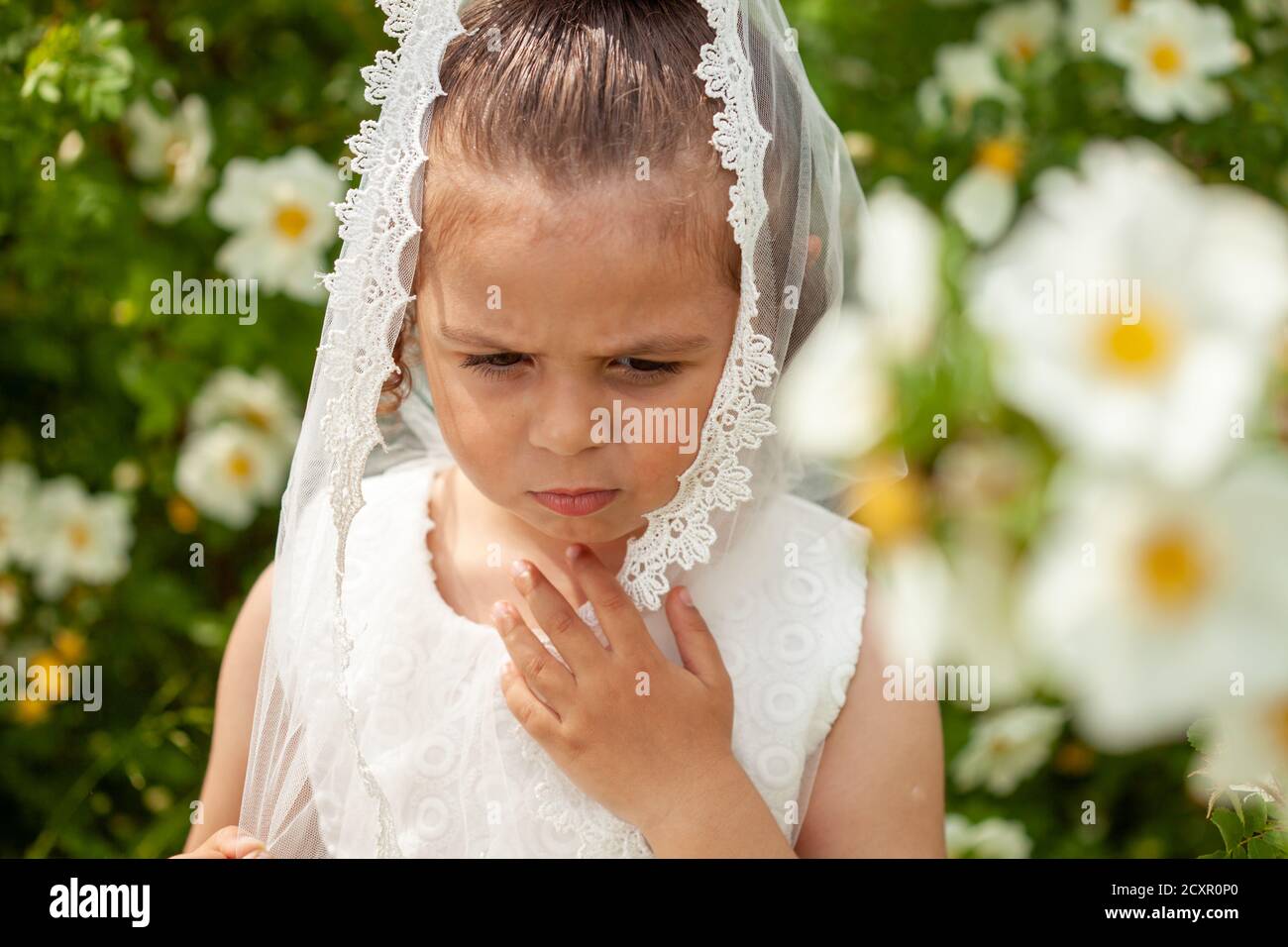 A little girl in a white dress of the bride in nature Stock Photo - Alamy