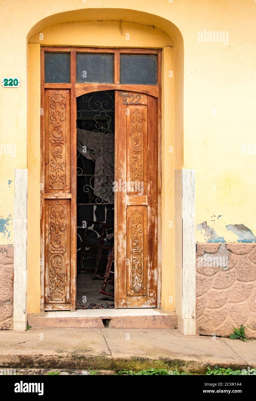 Trinidaad, Cuba Nov 26, 2017 - Half open red door on yellow wall Stock ...