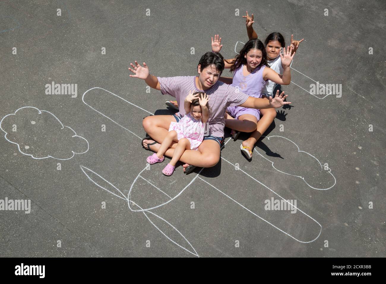 Young kids playing in a chalk drawn airplane Stock Photo - Alamy