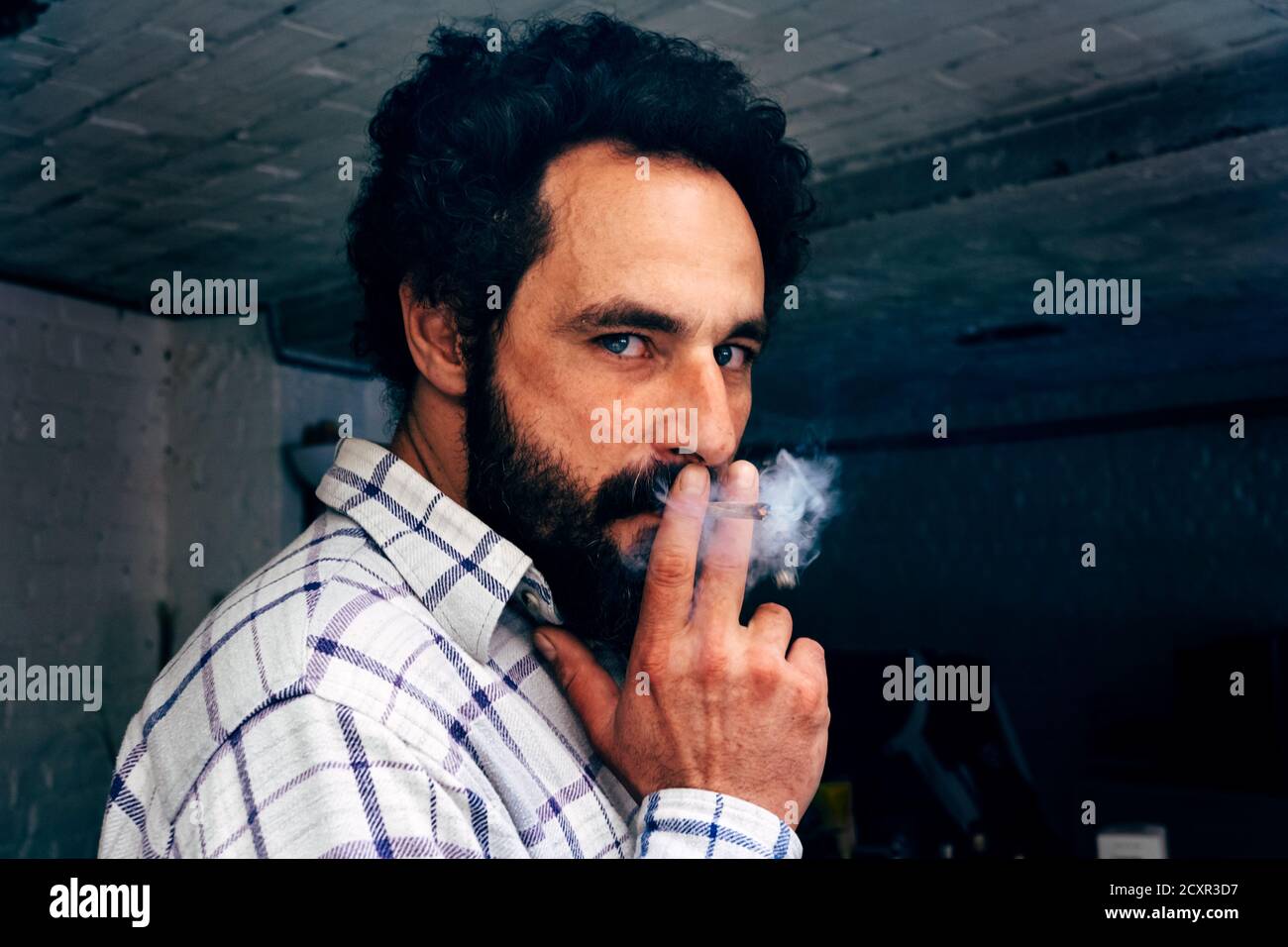 Handsome man smoking cigarette hi-res stock photography and images - Alamy