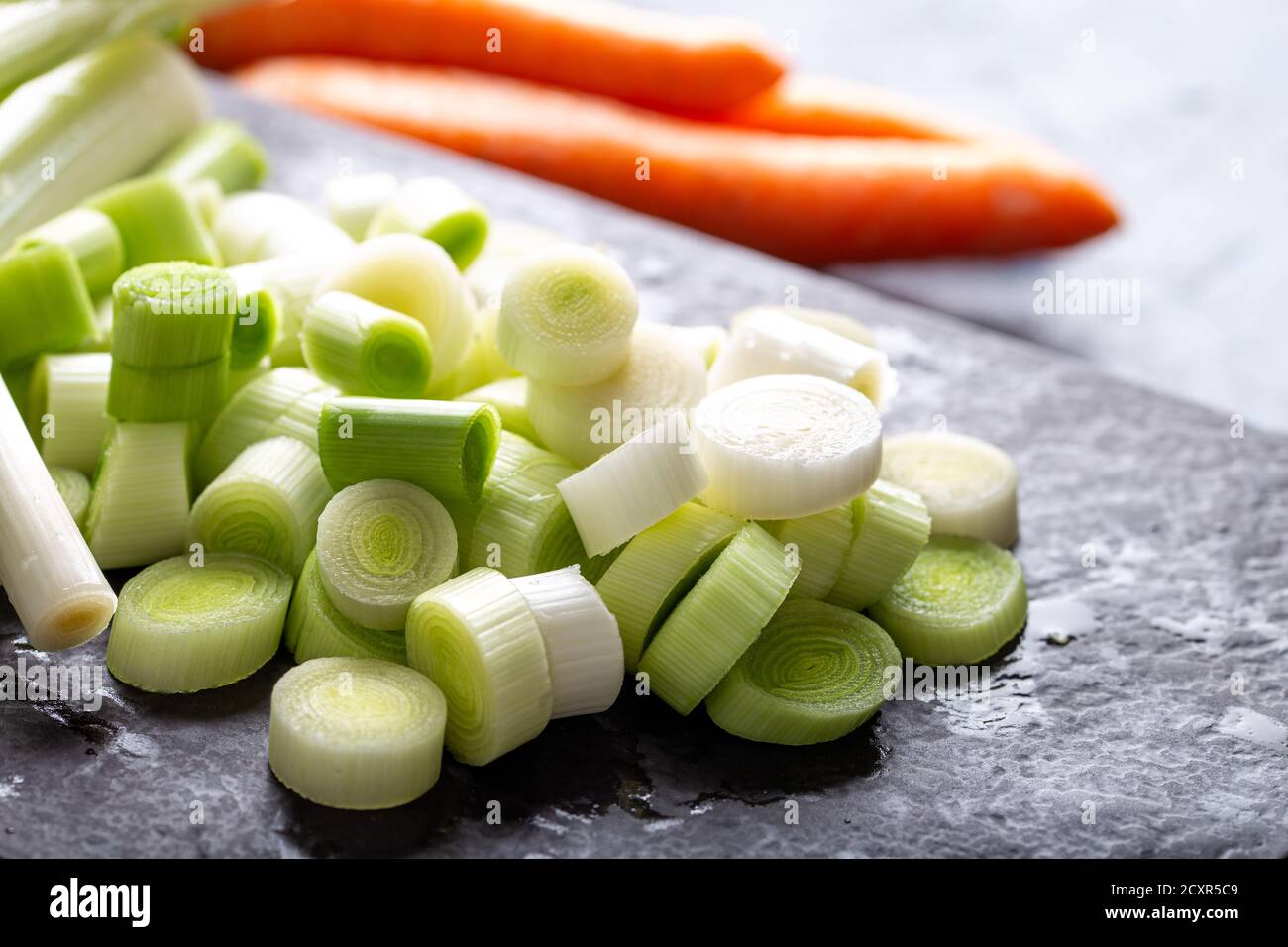 Washed sliced leek. sliced leek on stone cutting board Stock Photo - Alamy
