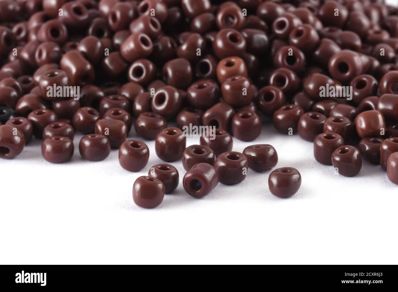 Close up of brown Beads on the white background. Background or texture ...