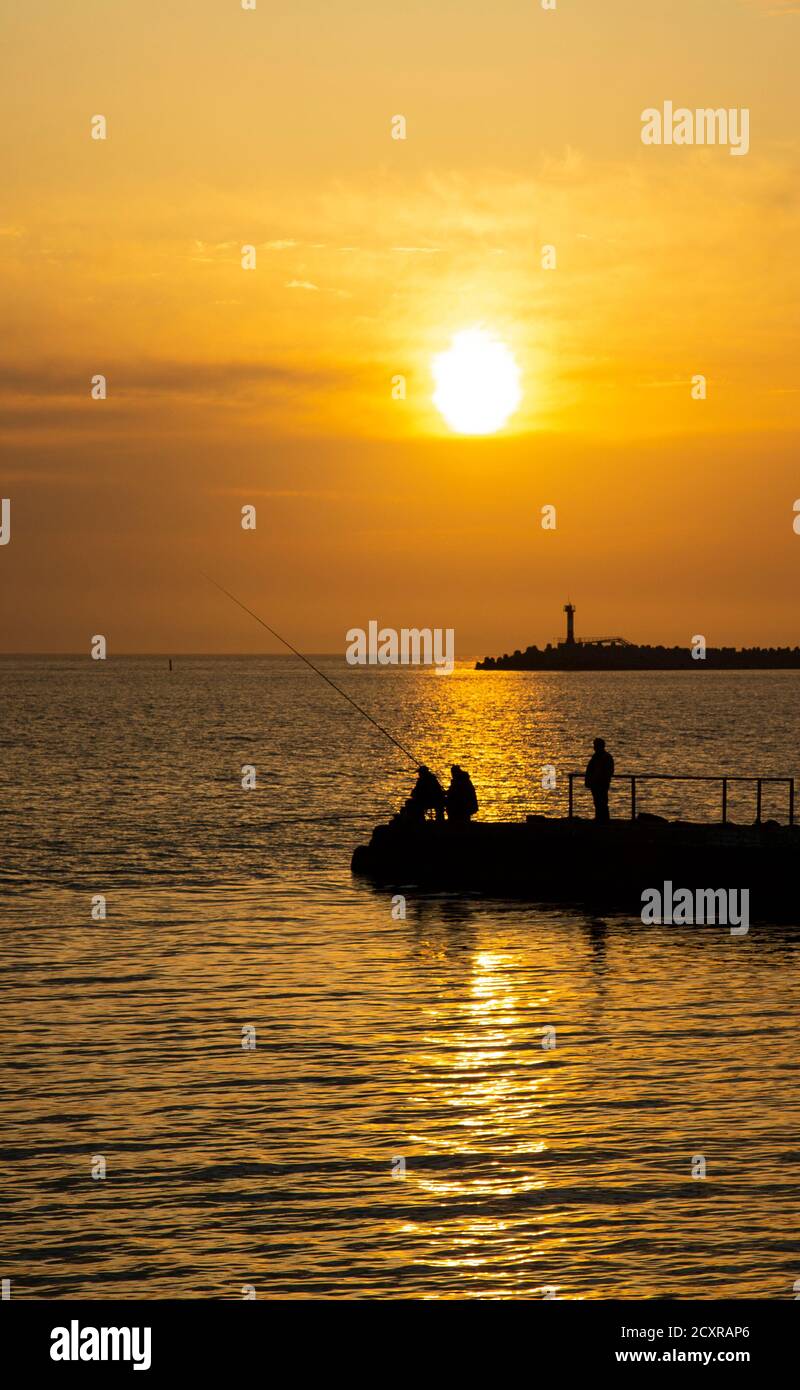 Man fishing in sea dusk activity hi-res stock photography and images ...