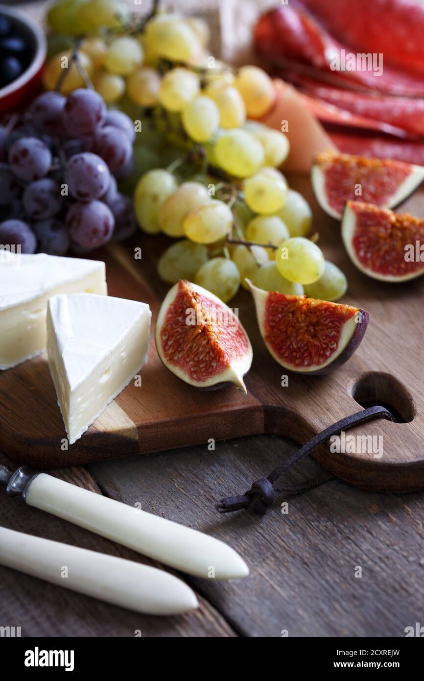 italian breakfast - grapes, brie cheese, salami, figs and olives Stock ...