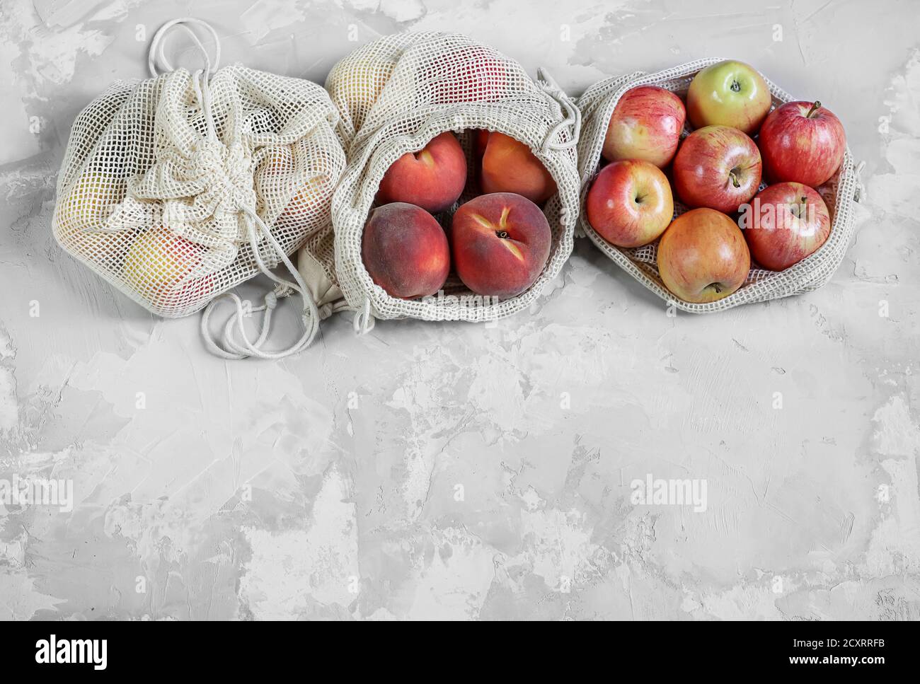 Zero waste concept: organic fruits - peaches and apples in reusable eco ...