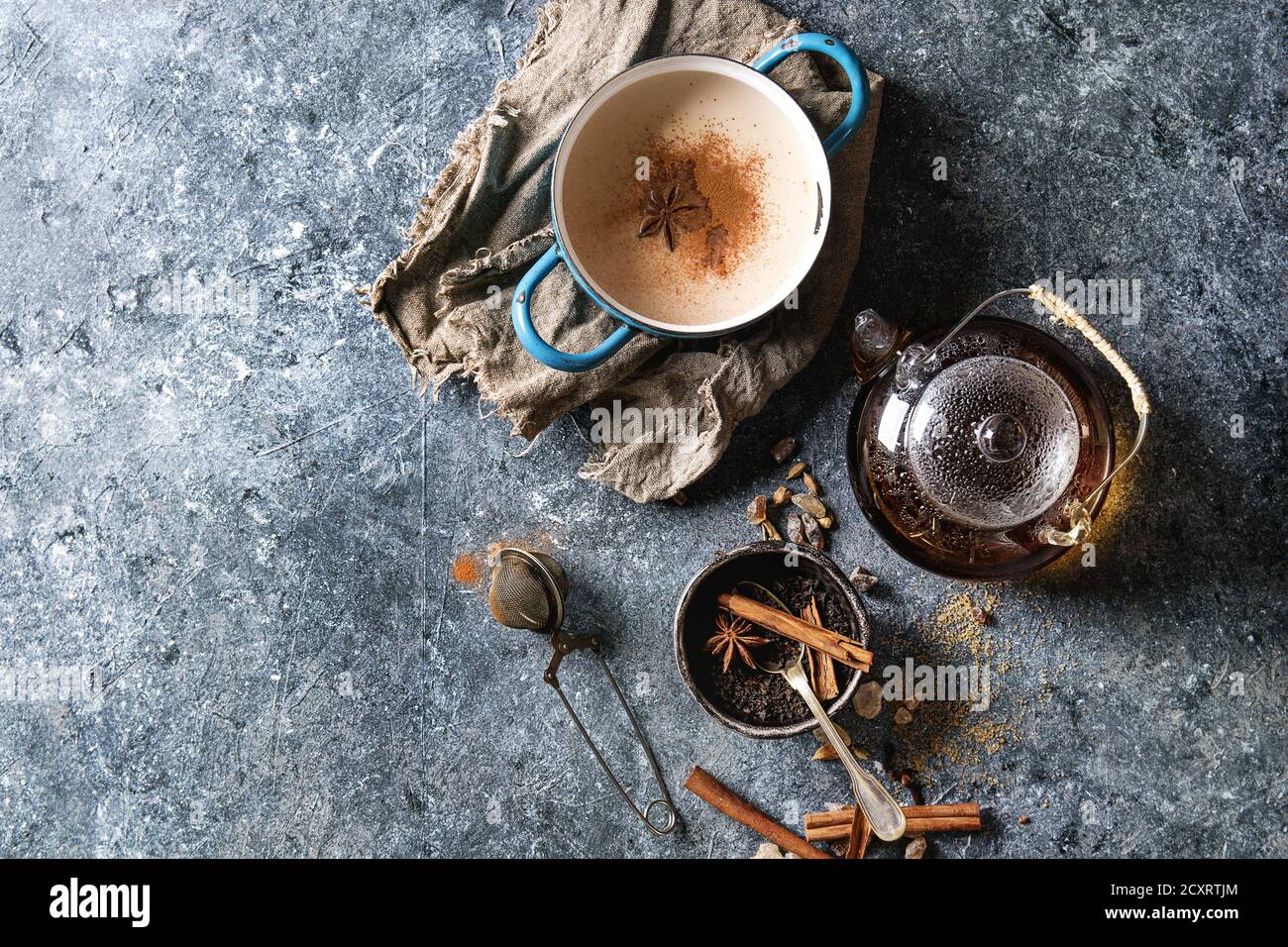 Vintage blue pot of traditional indian masala chai tea with ingredients ...
