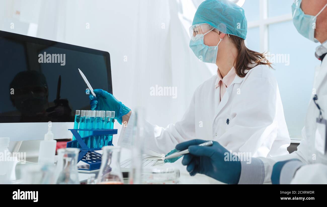 group of scientists looking at a computer screen in the laboratory ...