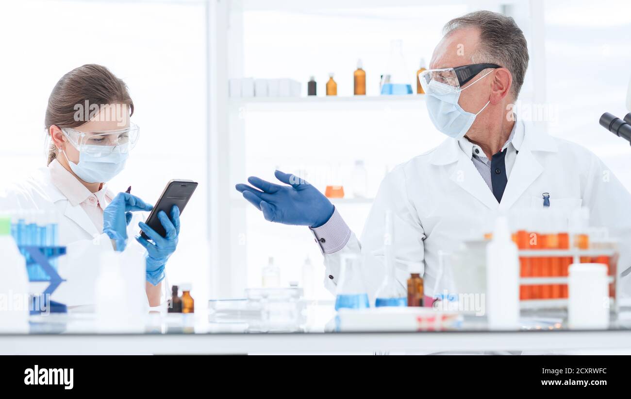 Laboratory assistant holding pipette dispenser hi-res stock photography ...