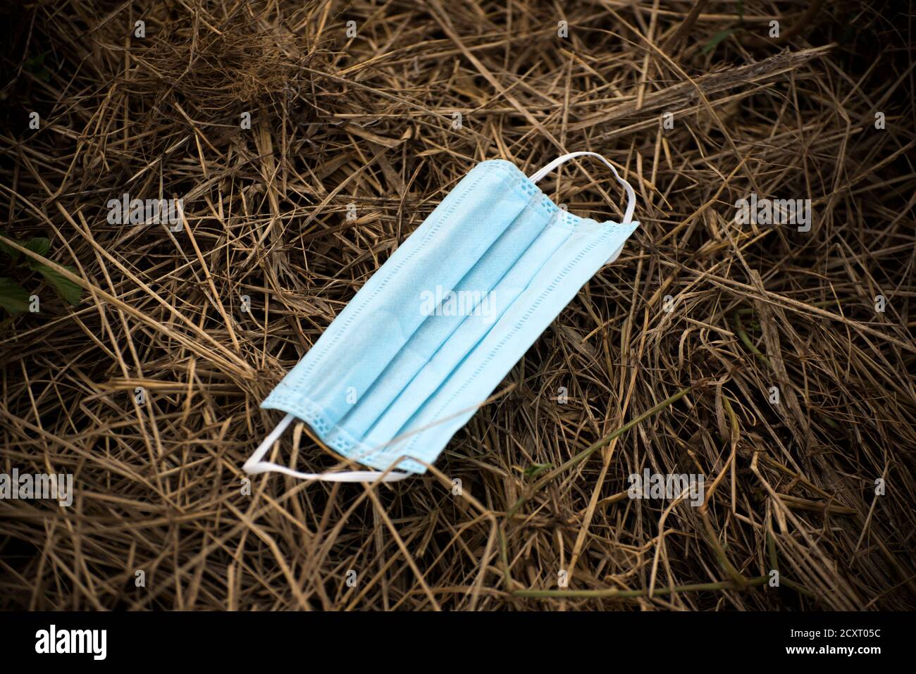 Medical face mask on the ground during the Covid-19 pandemic. The face ...