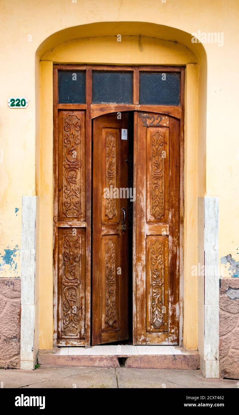 Trinidaad, Cuba Nov 26, 2017 - Tattered brown door with glass above on ...