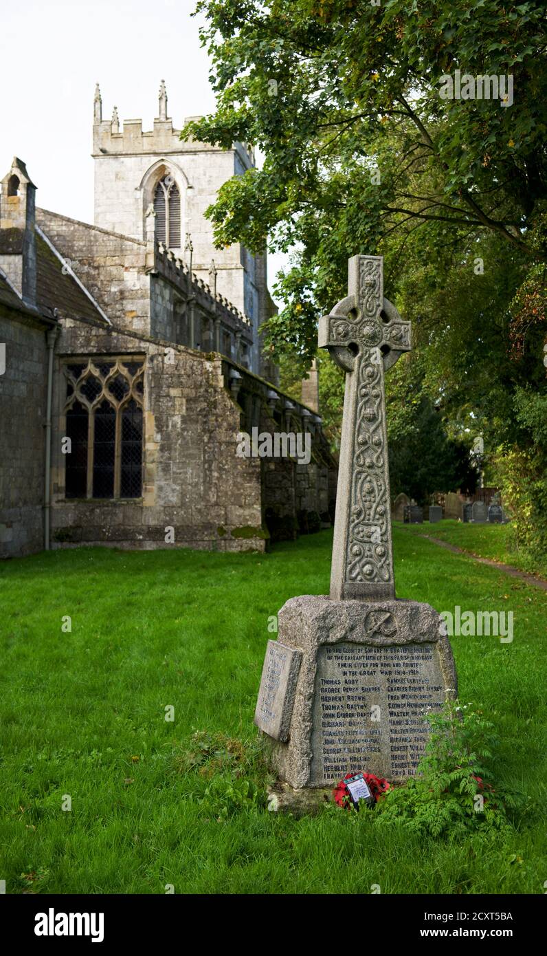 The war memorial and All Saints Church in the village of Bubwith, East ...