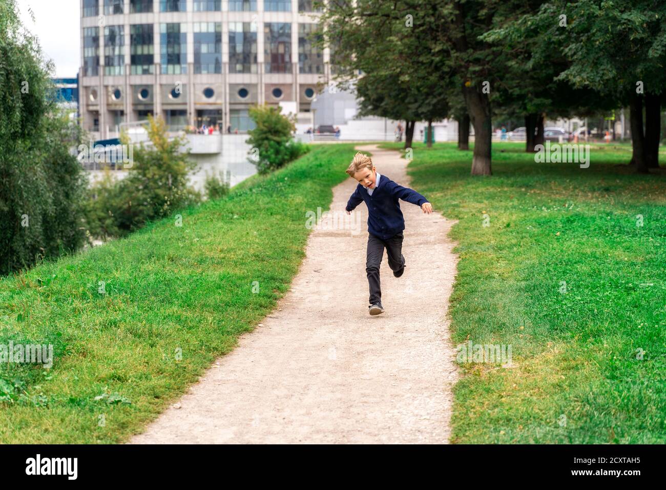the boy runs quickly along the path, arms to the sides Stock Photo - Alamy