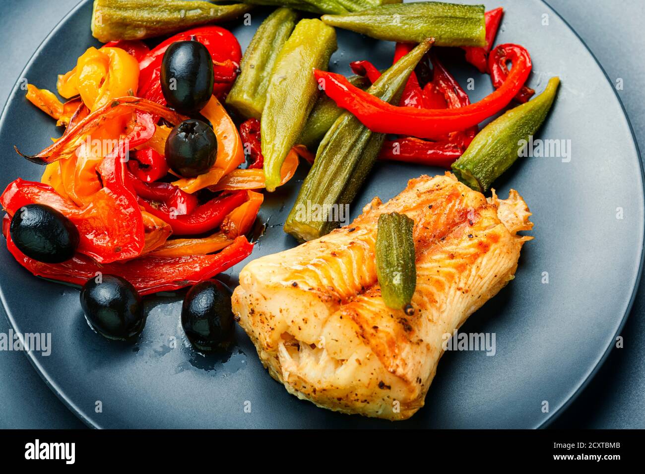 Baked fish with okra and red pepper.Fish grenadier Stock Photo - Alamy