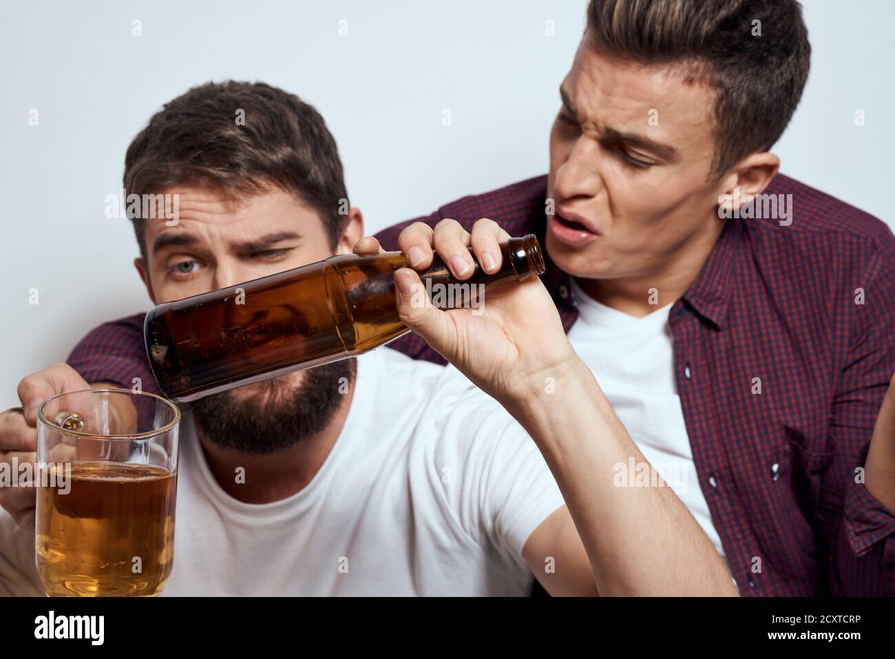 Two friends drink beer leisure fun alcohol friendship lifestyle light ...
