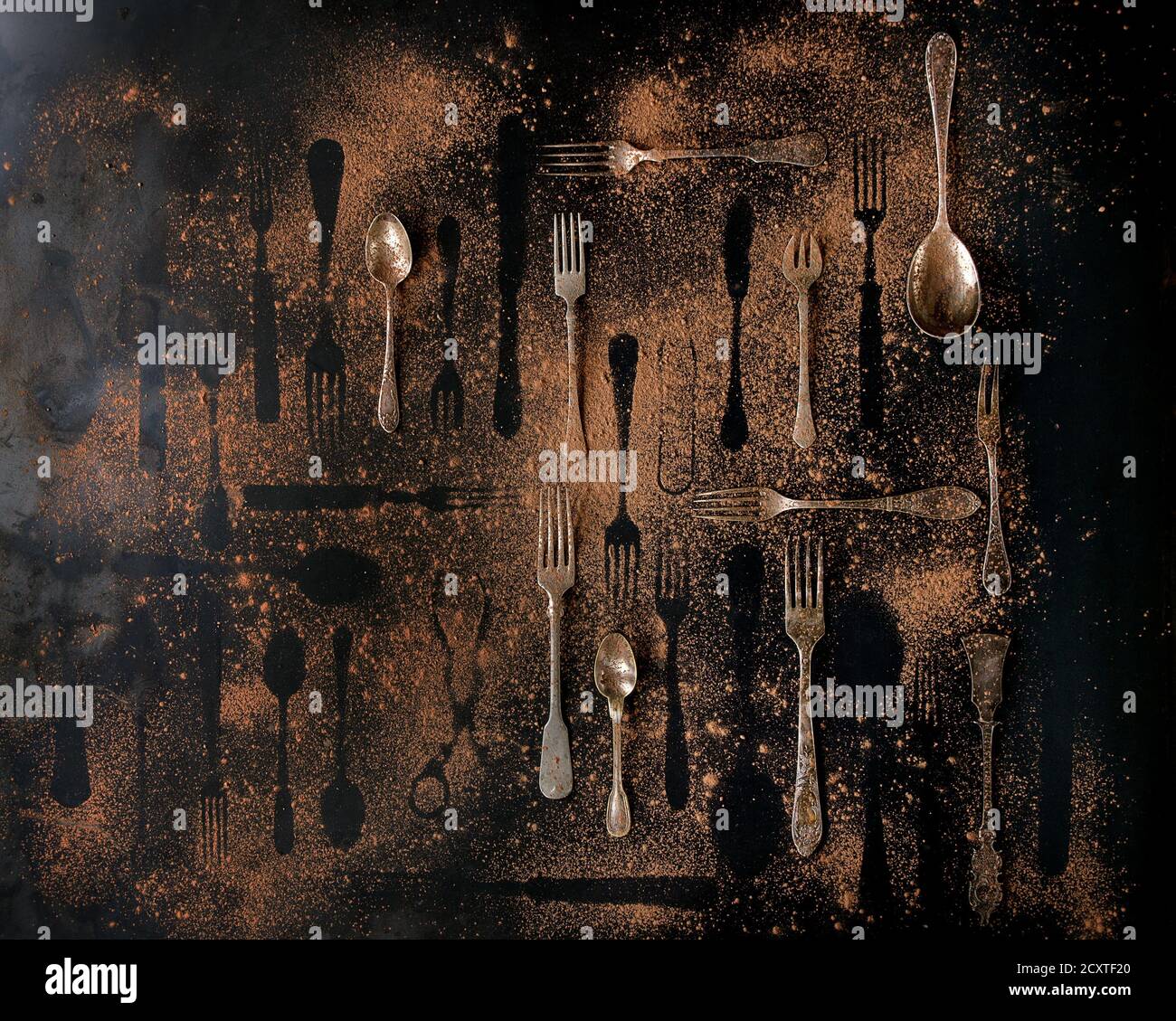 Big set of vintage and disappeared cutlery under brown dust over black ...