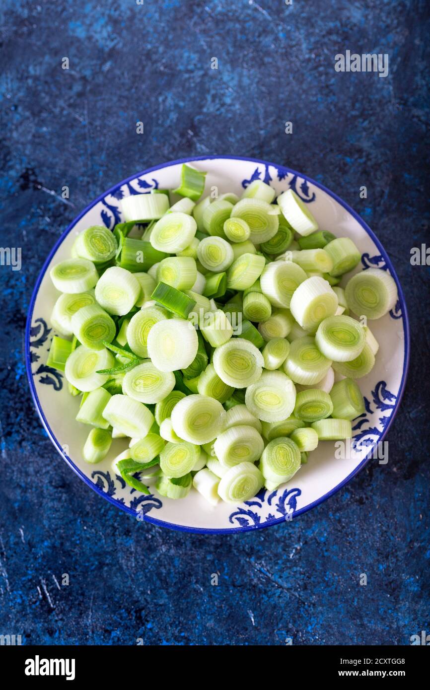 Fresh raw leek slice in a bowl. Washed sliced ready-to-cook leeks. Top ...