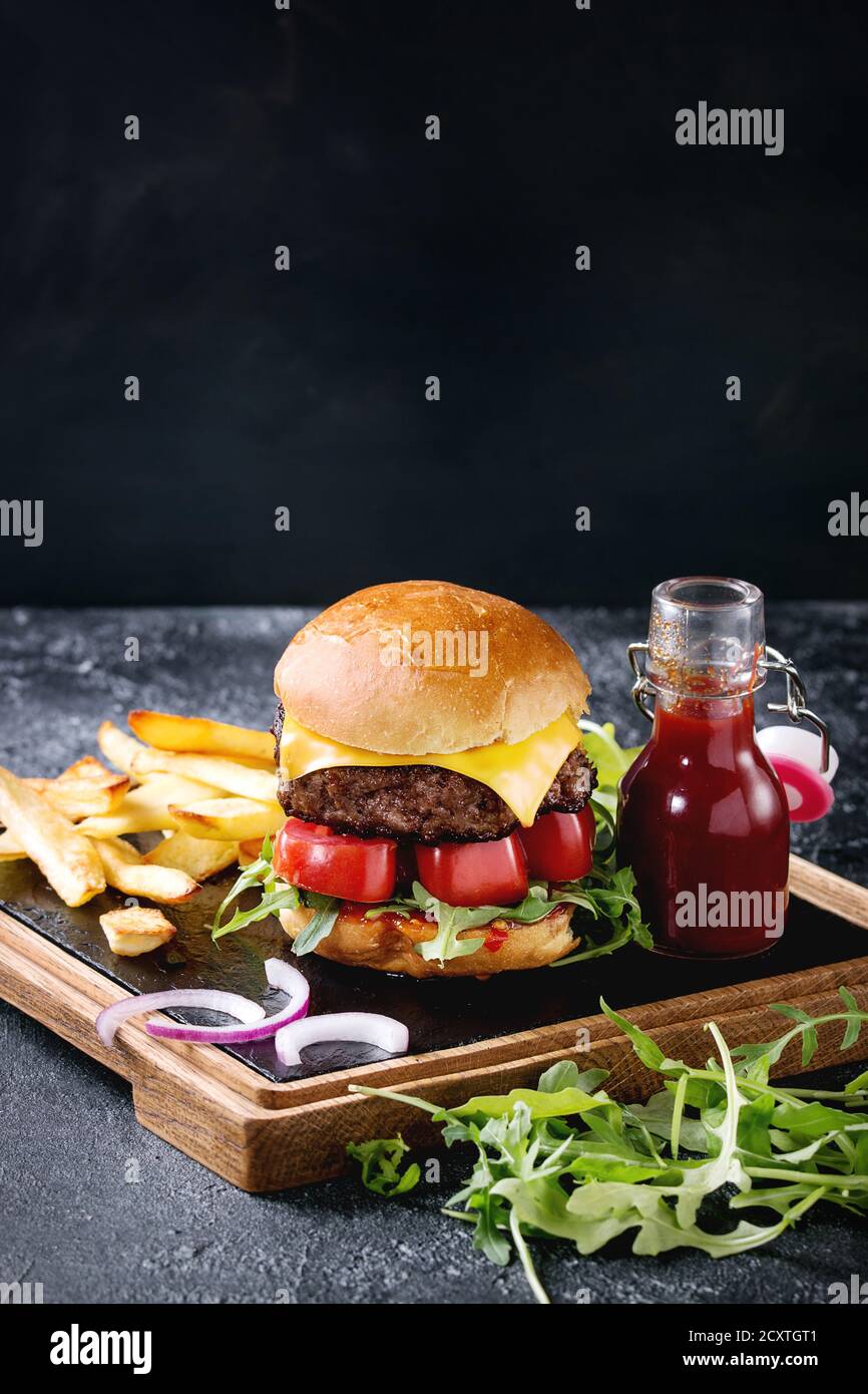 Homemade traditional hamburger with beef, tomato, cheese, aragula ...
