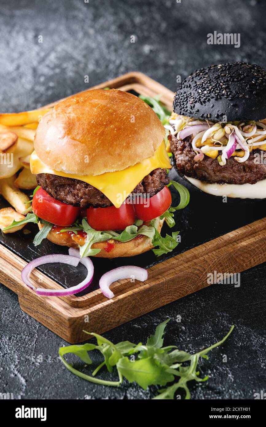 Homemade traditional hamburger with beef, tomato, cheese, aragula ...