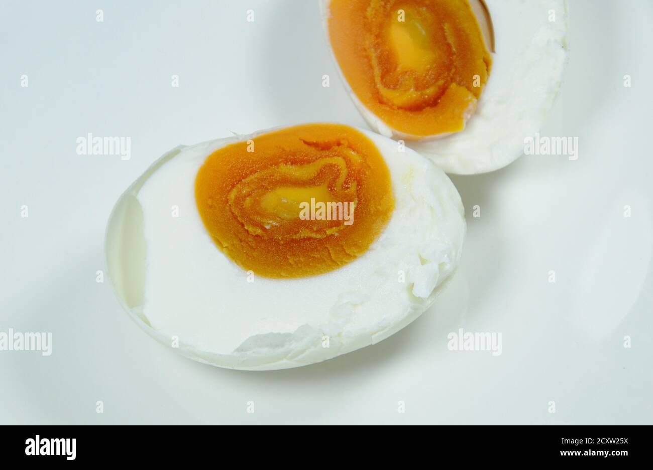 boiled salty egg half cut isolated on white background Stock Photo - Alamy