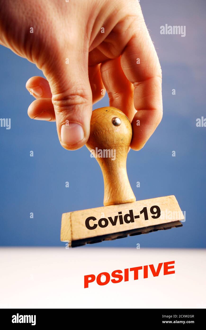 Covid 19 rubber stamp in hand with positive text on white Stock Photo ...
