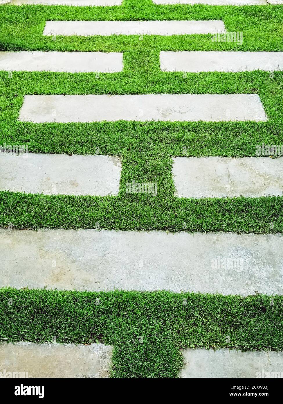 Walkway sheet stretching into the distance with green grass lawn in ...