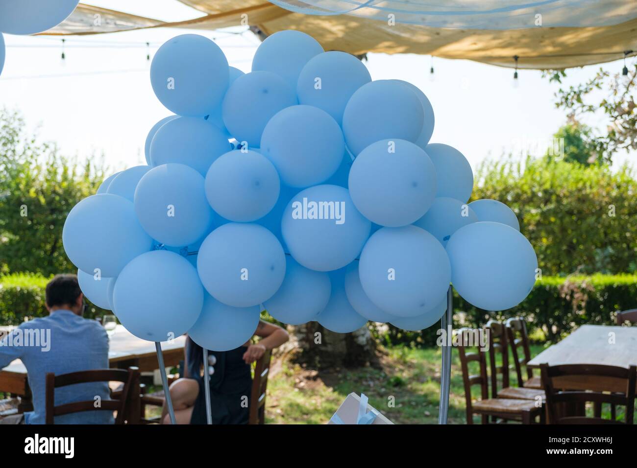 set up for baby baptism with puppets and blue balloons. High quality ...