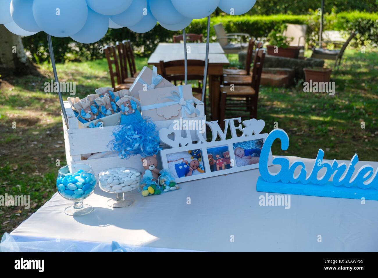 set up for baby baptism with puppets and blue balloons. High quality ...