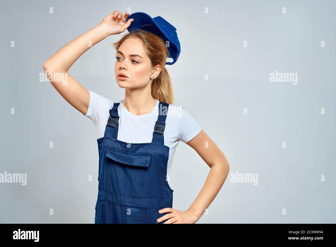 woman in work uniform blue cap service delivery service light ...