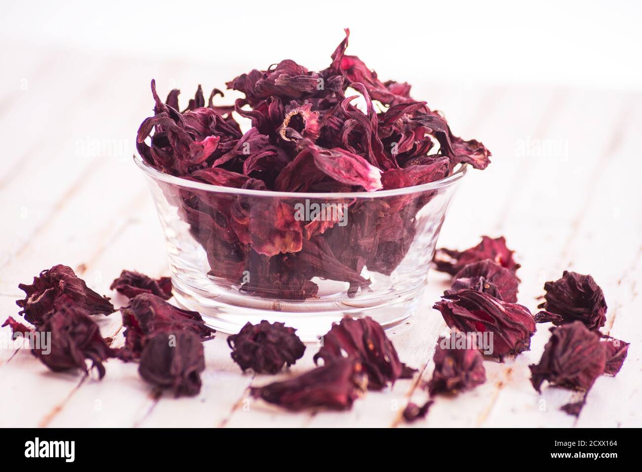 Dry flowers of Hibiscus sabdariffa (Roselle, karkade) in glass bowl on ...