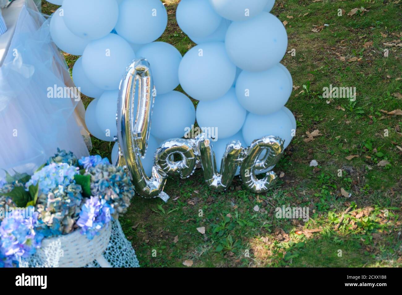 set up for baby baptism with puppets and blue balloons. High quality ...